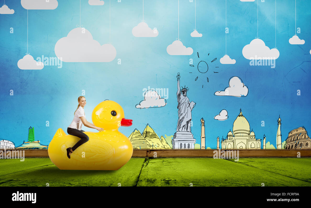 Young happy businesswoman riding yellow rubber duck Stock Photo - Alamy