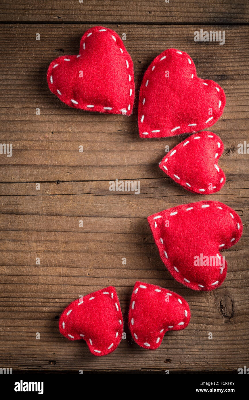 Small red hearts on vintage wooden surface Stock Photo - Alamy