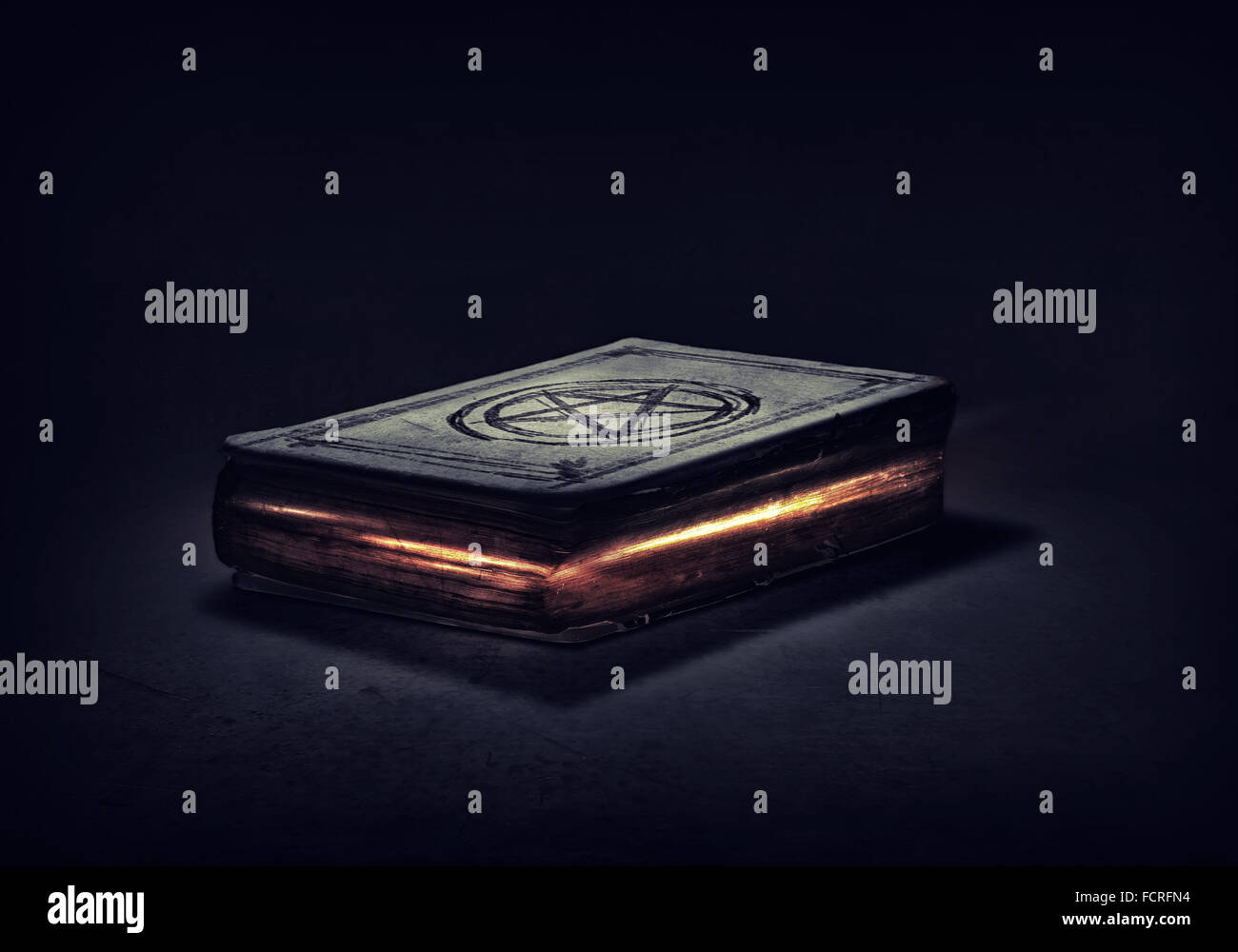 Old black magic book lights hi-res stock photography and images - Alamy