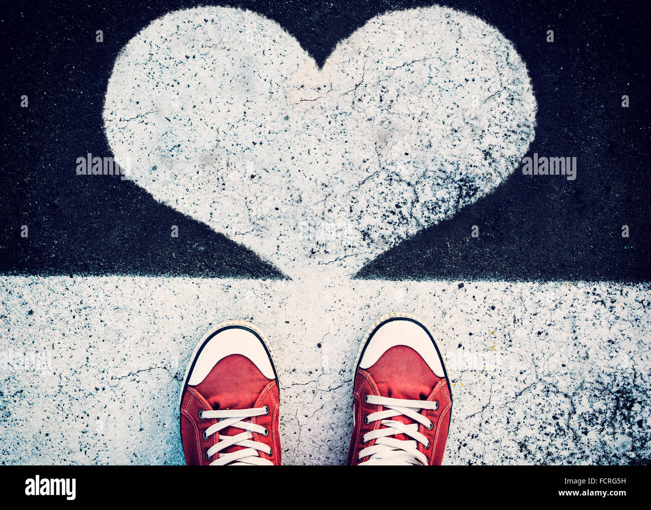 Student standing above the sign for love Stock Photo - Alamy