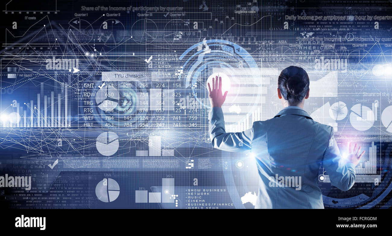 Back view of businesswoman working with modern virtual technologies ...