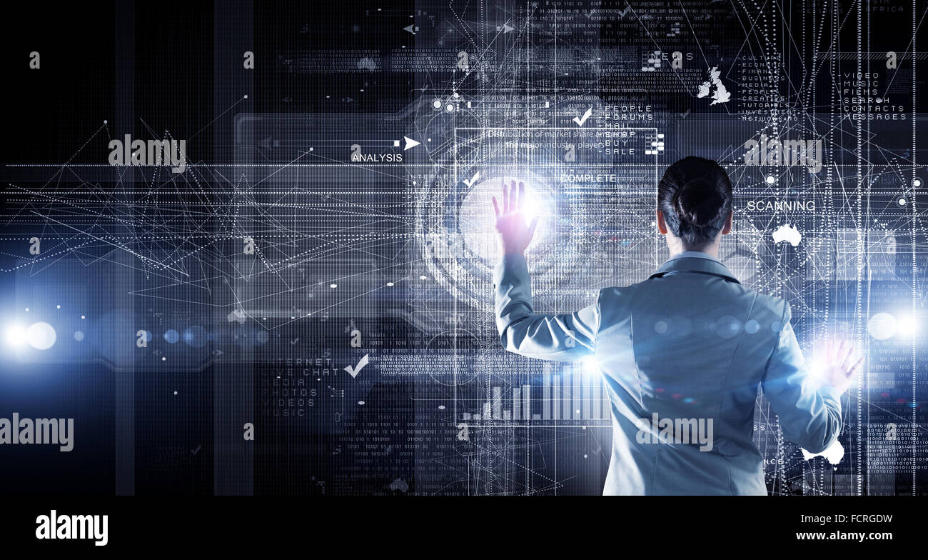 Back view of businesswoman working with modern virtual technologies ...