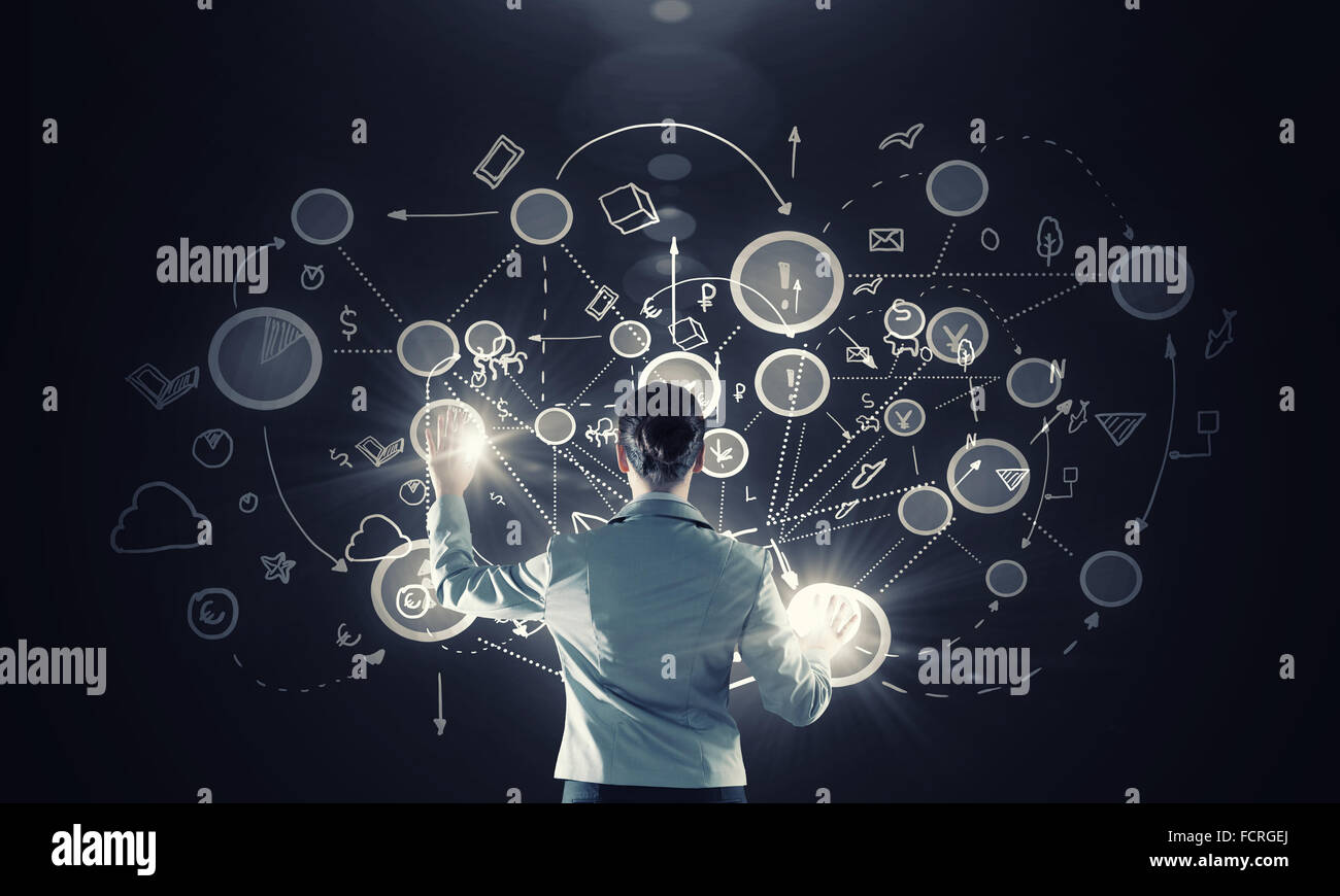 Back view of businesswoman working with modern virtual technologies ...