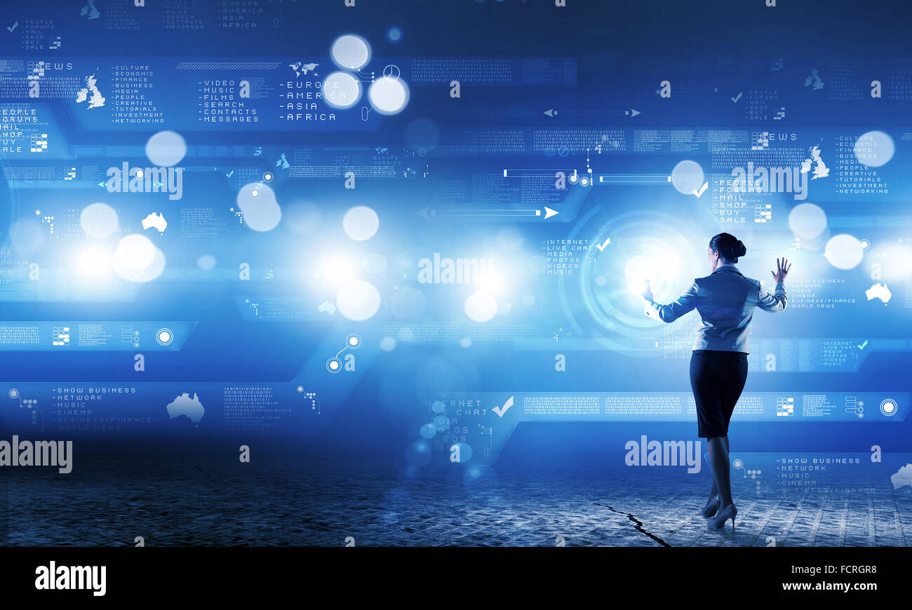 Back view of businesswoman working with modern virtual technologies ...