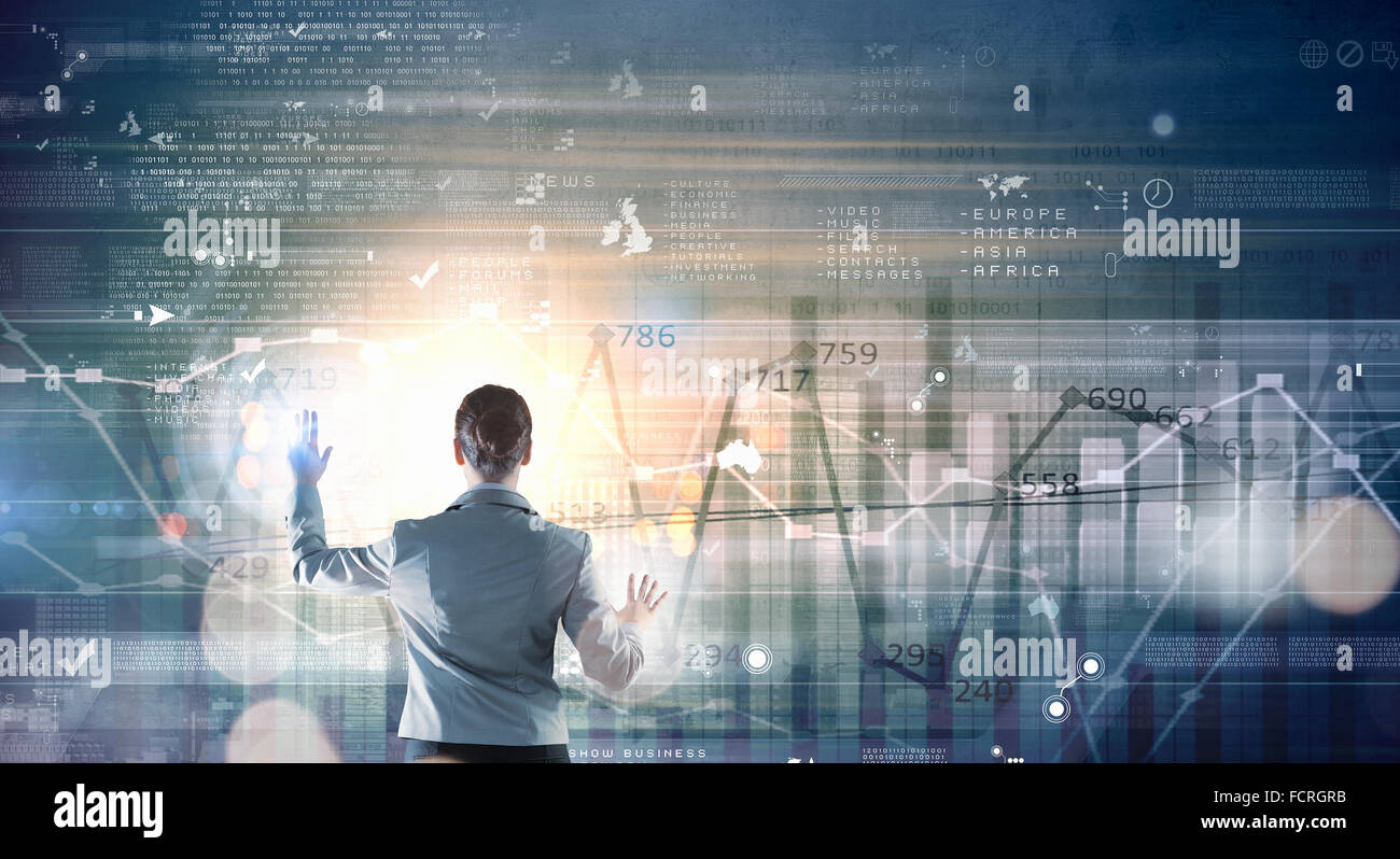 Back view of businesswoman working with modern virtual technologies ...