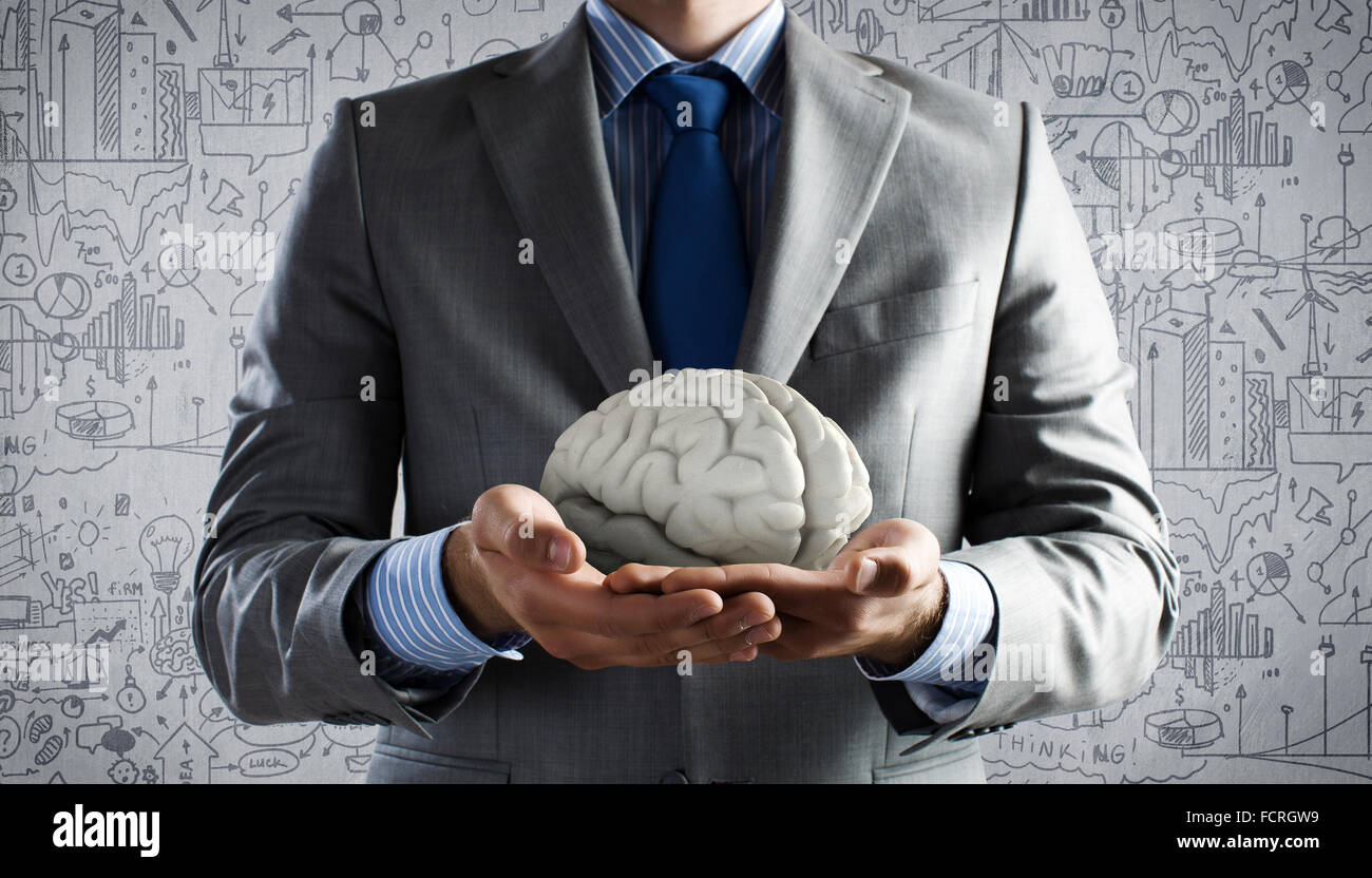 Close up of businessman holding human brain in palms Stock Photo - Alamy