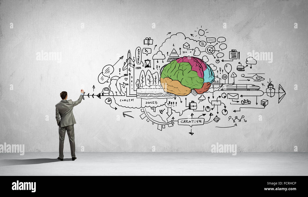Back view of businessman drawing human brain on wall Stock Photo - Alamy