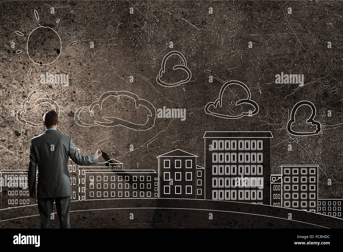 Back view of businessman drawing sketches of construction project on ...
