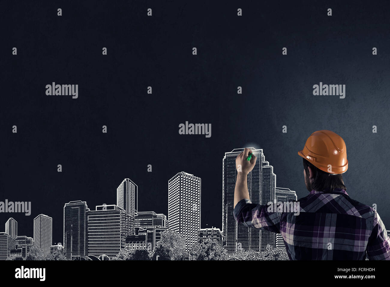 Back view of businessman drawing sketches of construction project on ...