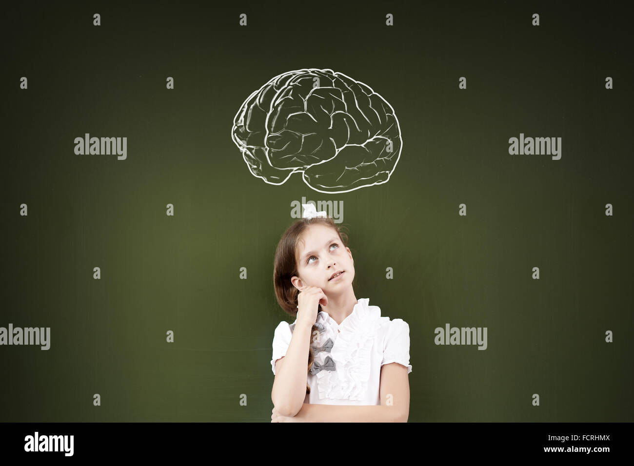 Pretty girl of school age standing at blackboard Stock Photo - Alamy