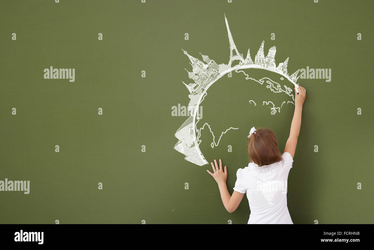 Cute girl of school age writing with chalk on blackboard Stock Photo ...
