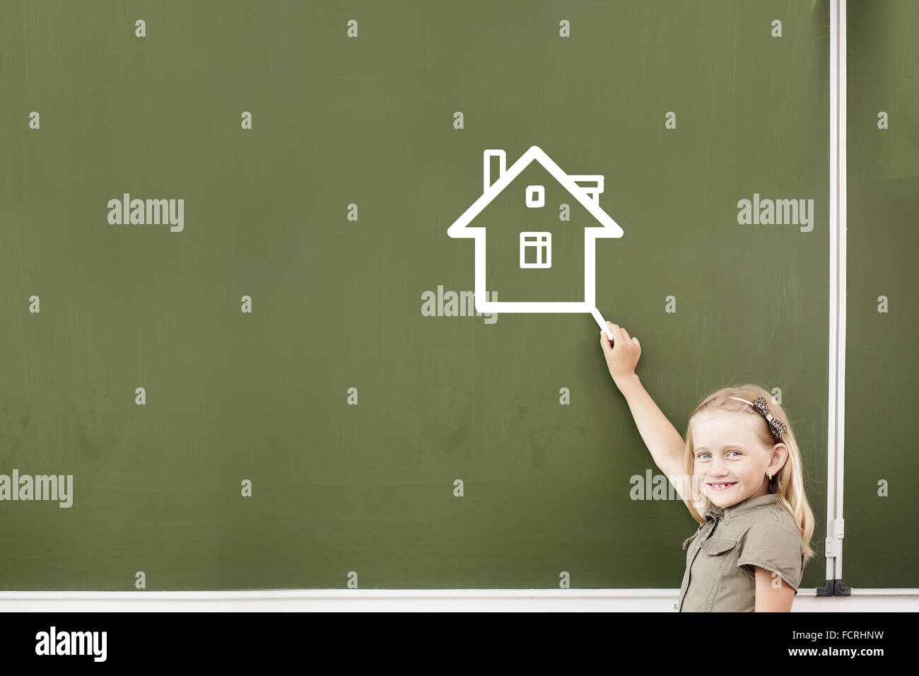 Cute girl of school age writing with chalk on blackboard Stock Photo ...