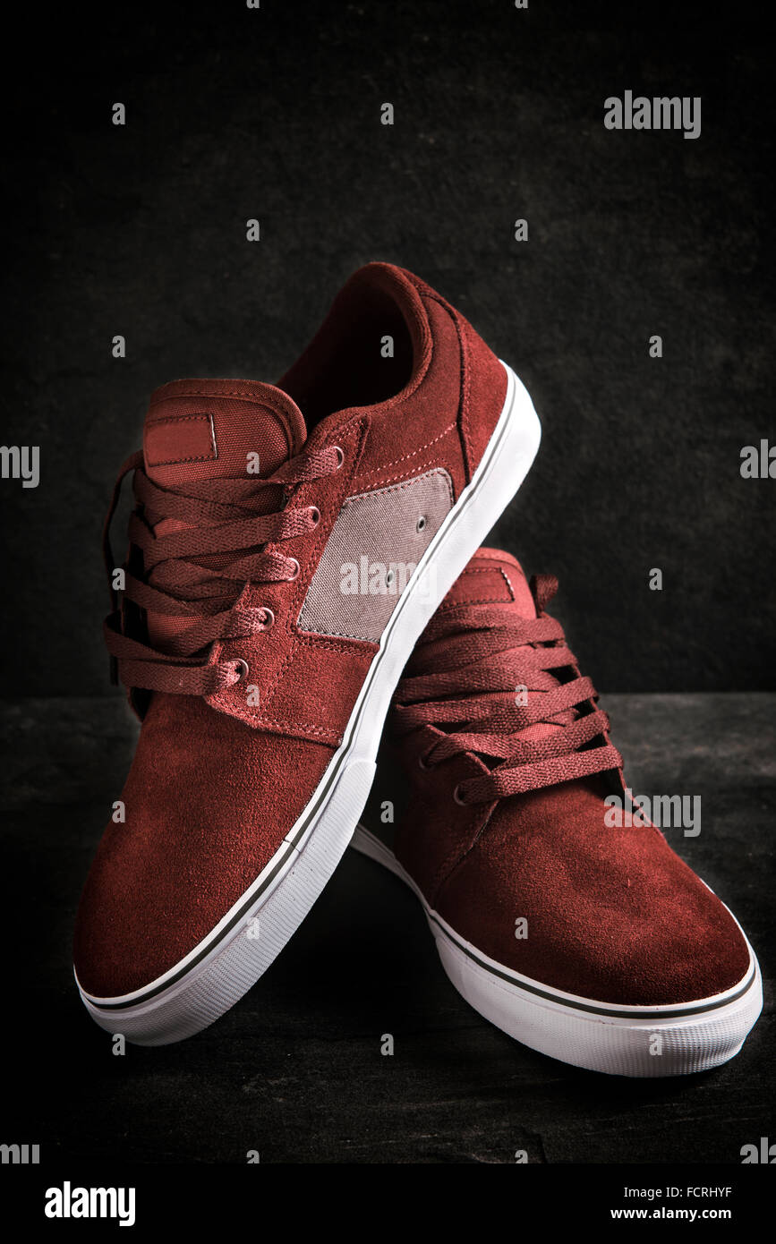 Red skater sneakers on dark background Stock Photo - Alamy