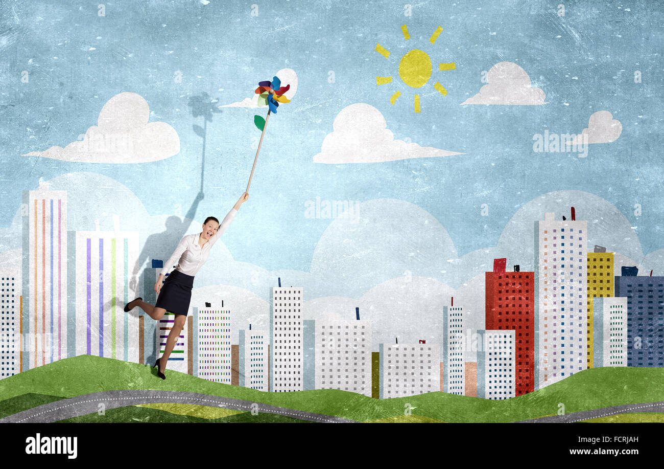 Beautiful young caucasian businesswoman flying on windmill Stock Photo ...