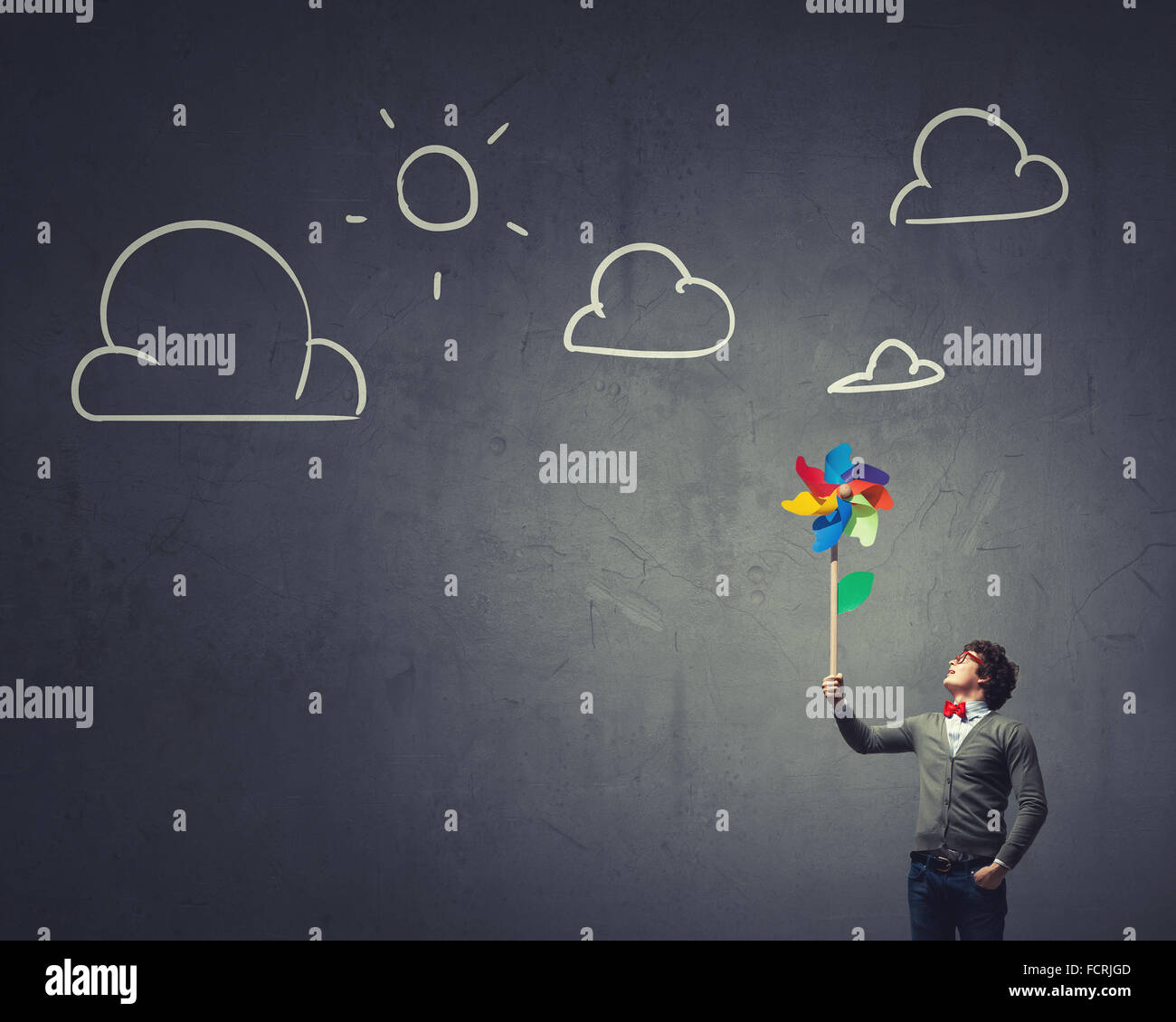 Young happy businessman with colorful windmill in hand Stock Photo - Alamy