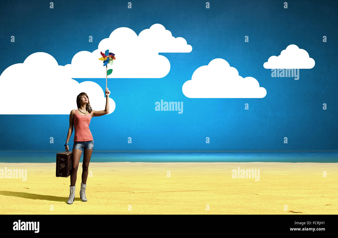 Happy young woman with windmill in hand Stock Photo - Alamy