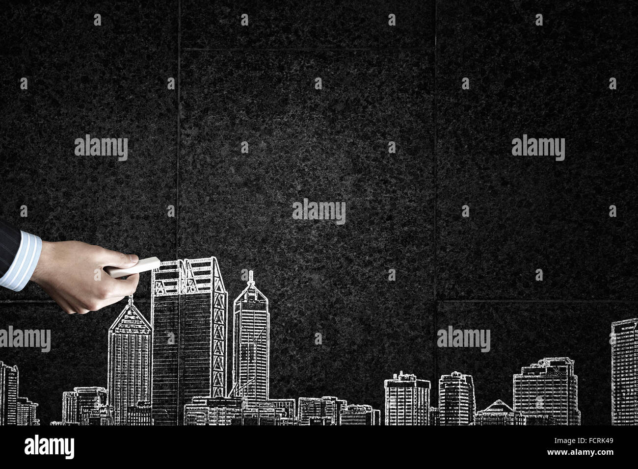 Close up of hand drawing urban city building on chalk board Stock Photo ...