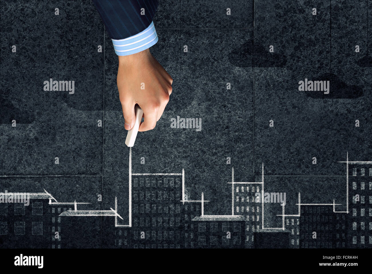 Close up of hand drawing urban city building on chalk board Stock Photo ...