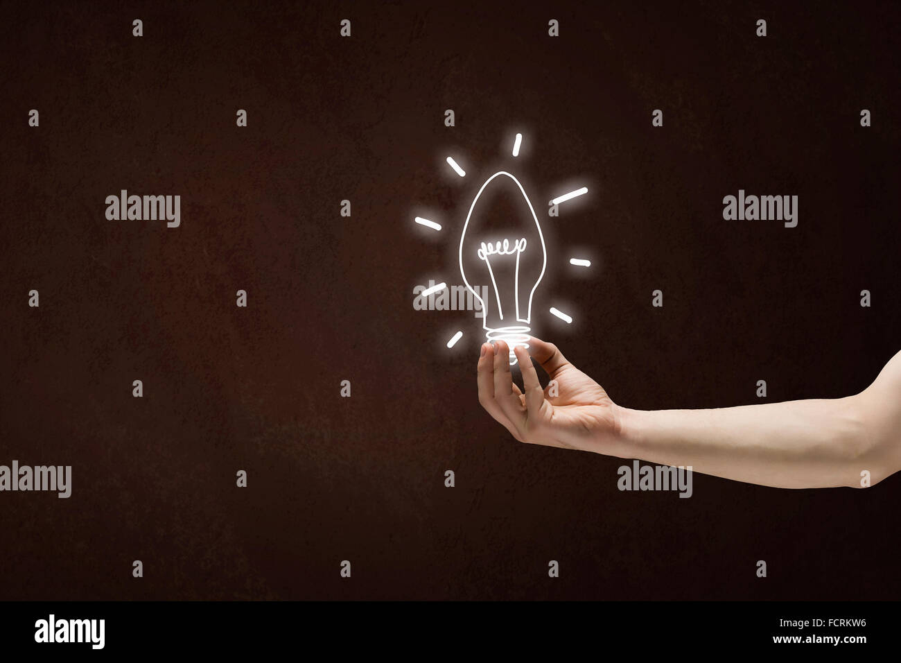 Human hand on dark background holding light bulb Stock Photo - Alamy