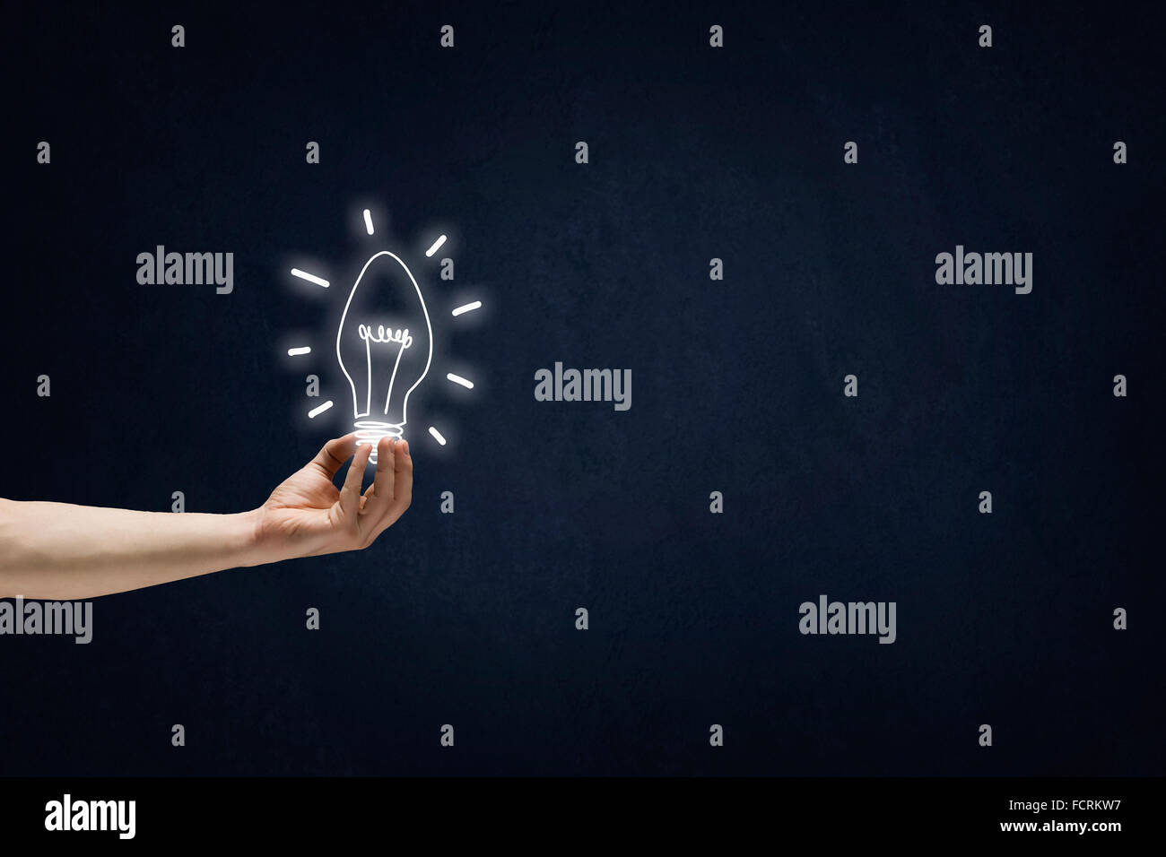 Human hand on dark background holding light bulb Stock Photo - Alamy