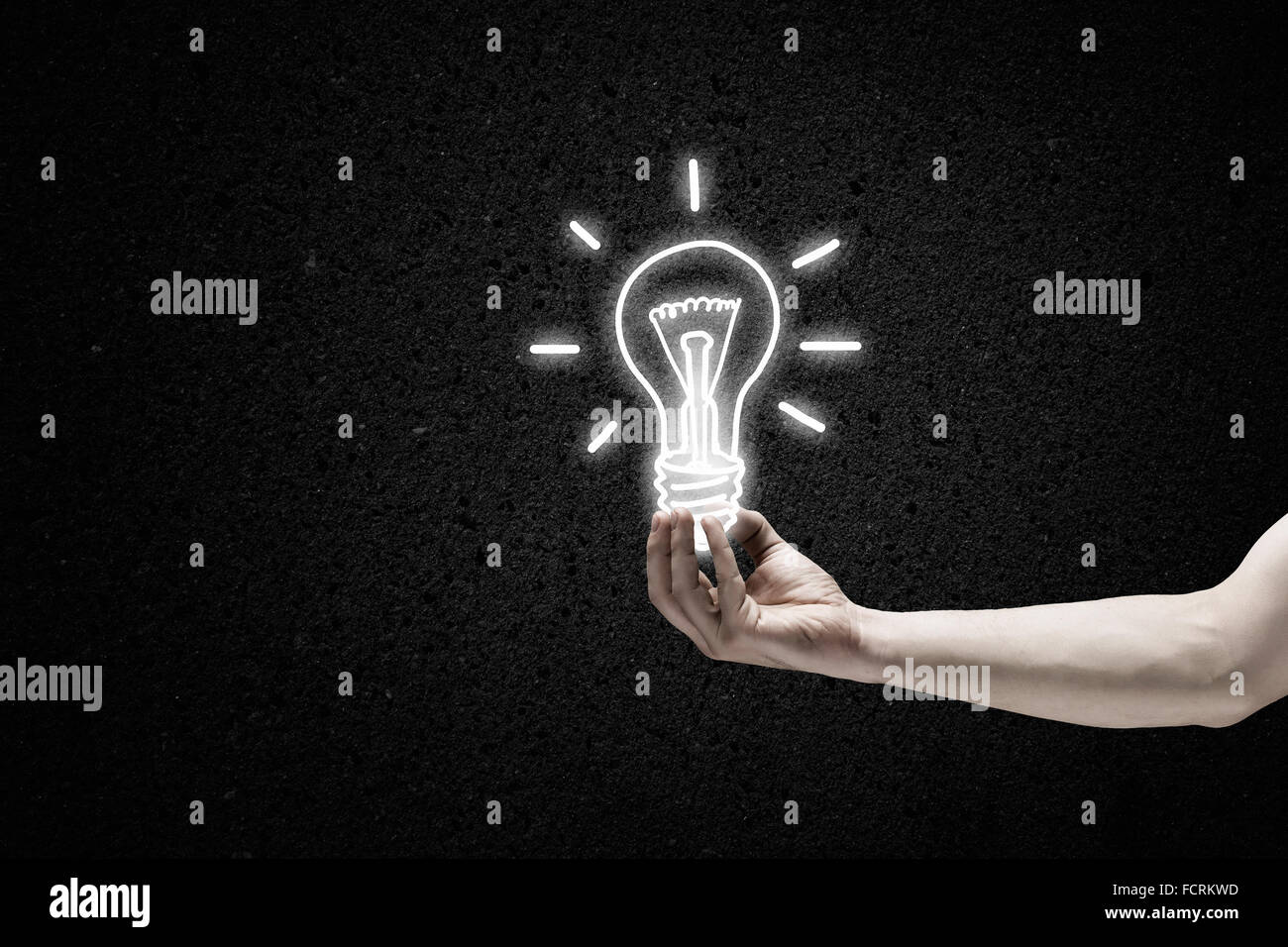 Human hand on dark background holding light bulb Stock Photo - Alamy