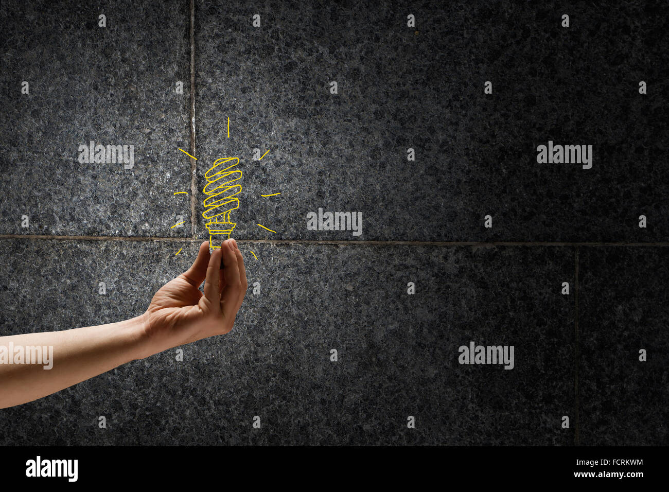 Human hand on dark background holding light bulb Stock Photo - Alamy