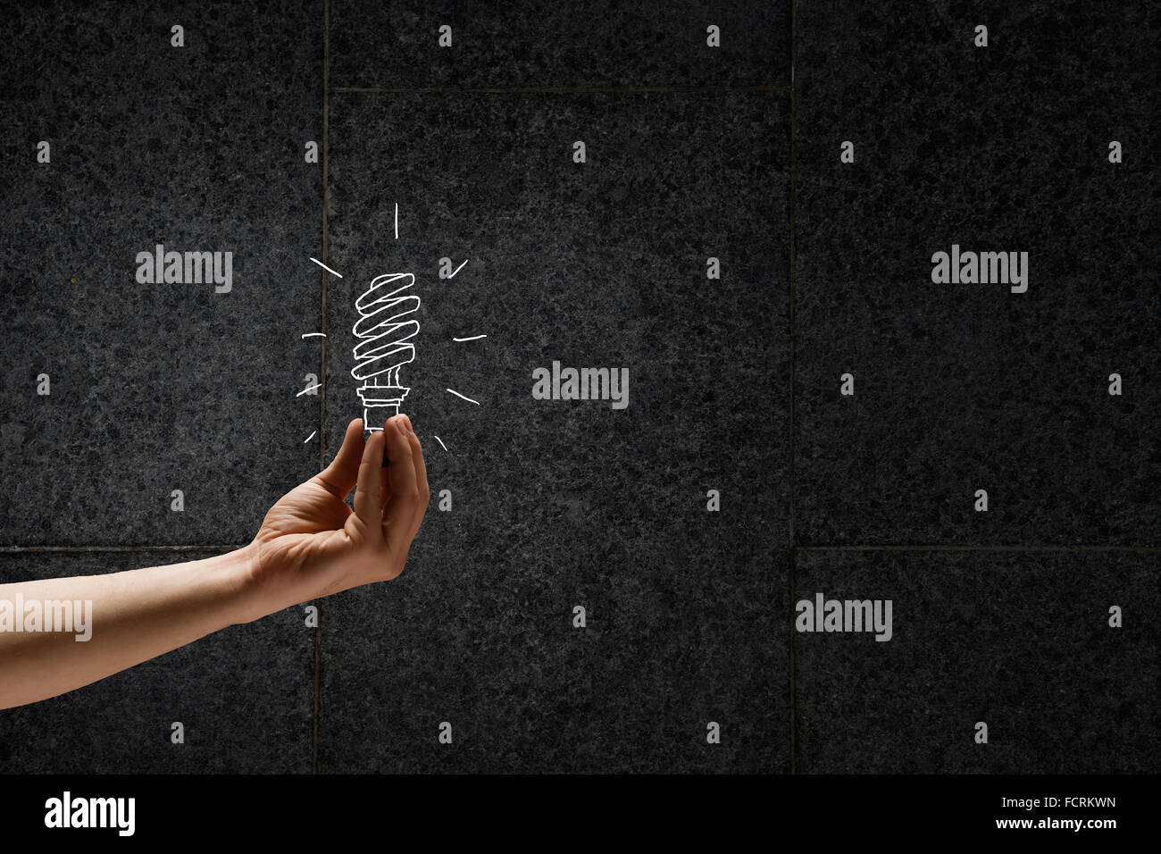 Human hand on dark background holding light bulb Stock Photo - Alamy