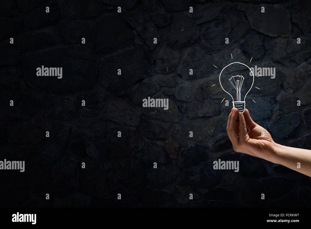 Human hand on dark background holding light bulb Stock Photo - Alamy