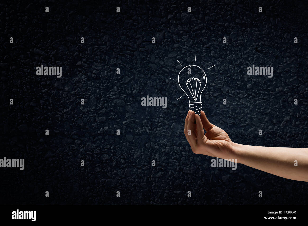 Human hand on dark background holding light bulb Stock Photo - Alamy