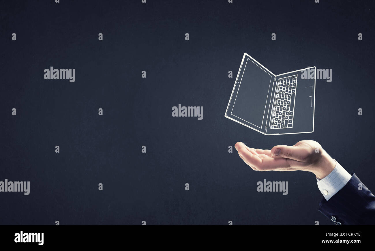 Human hand holding in palm laptop symbol Stock Photo - Alamy