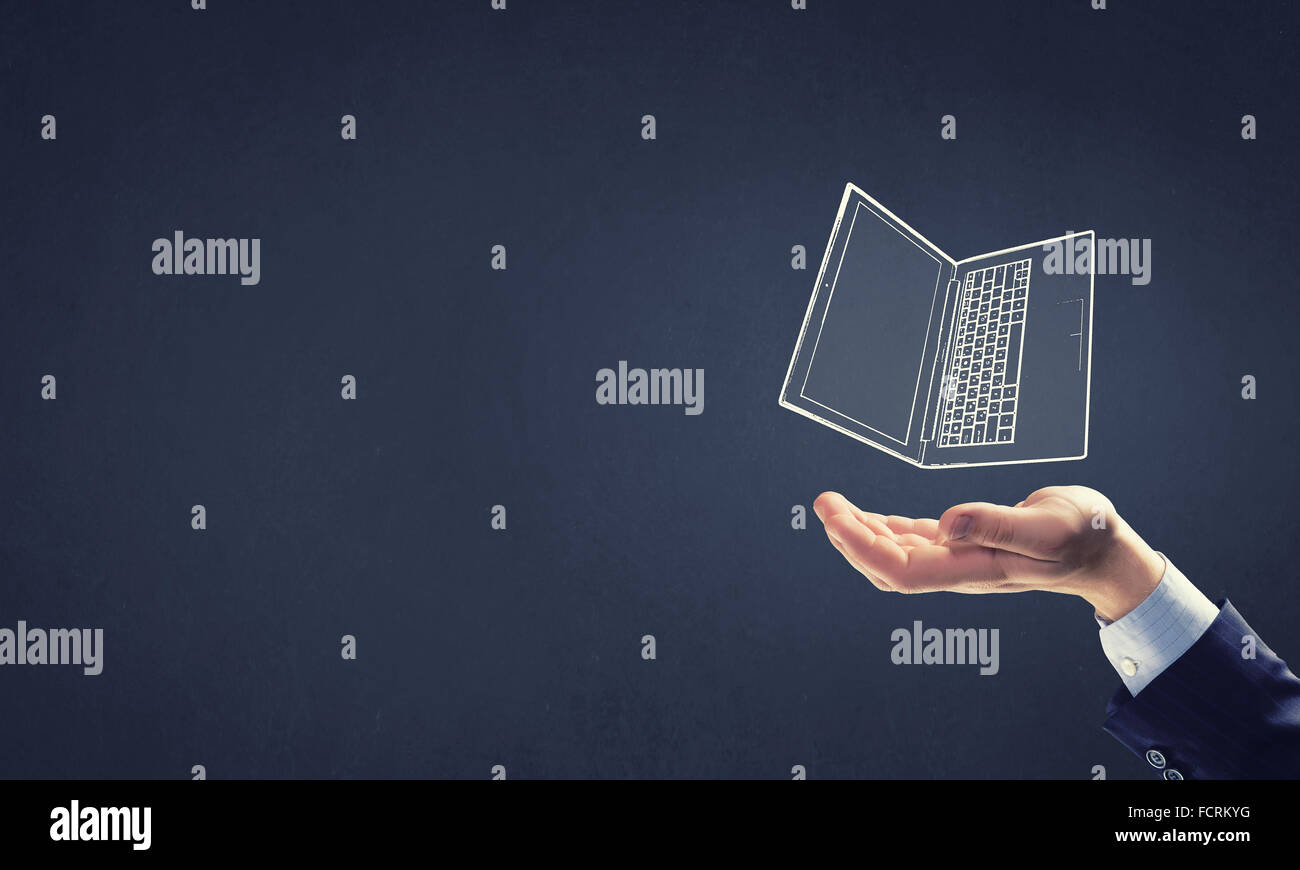 Human hand holding in palm laptop symbol Stock Photo - Alamy