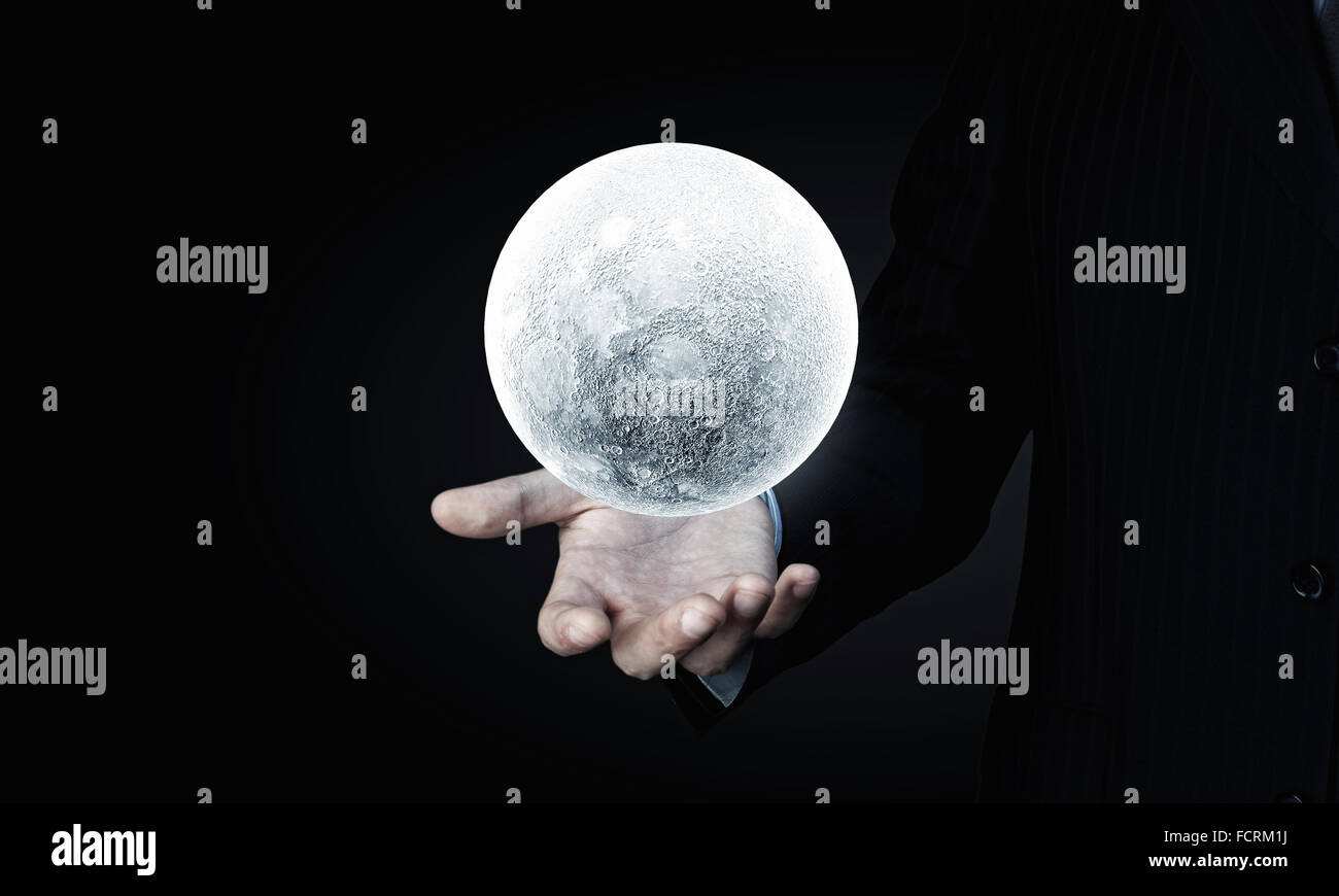Close of man hands holding moon planet Stock Photo - Alamy