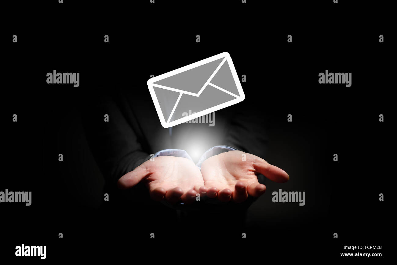 Close up of businessman hand holding email sign Stock Photo - Alamy
