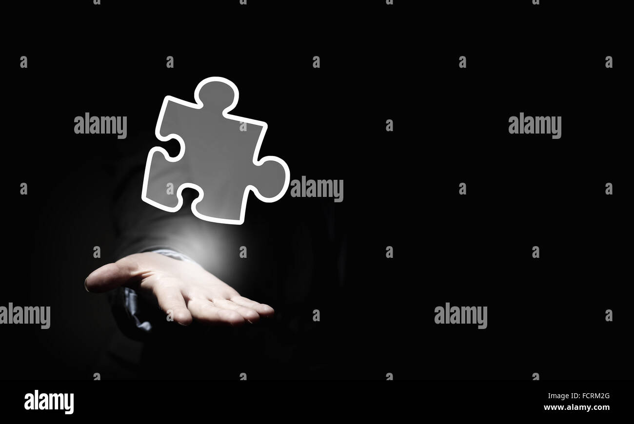 Close up of businessman's hand holding puzzle piece Stock Photo - Alamy