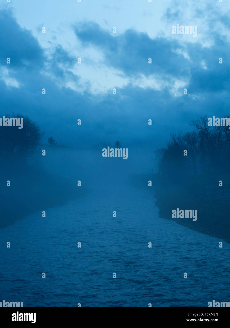 Open river on a cloudy and foggy winter day Stock Photo - Alamy