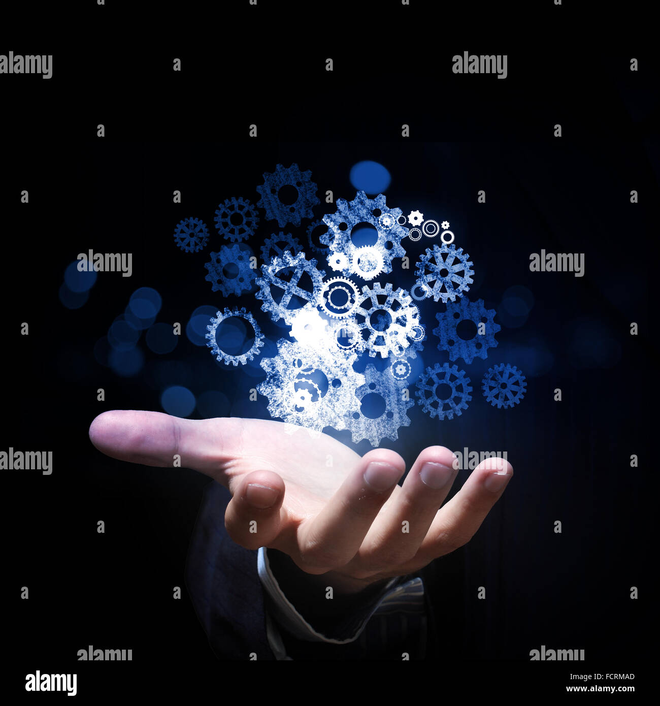 Close up of human hand holding gear icons Stock Photo - Alamy