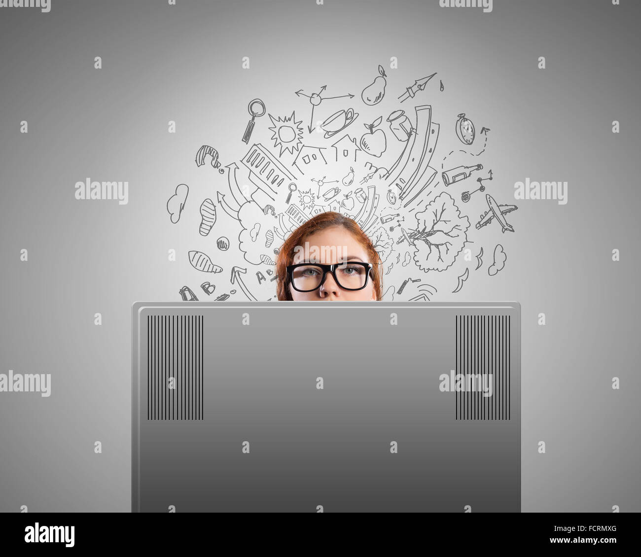 Young woman looking out above laptop monitor Stock Photo - Alamy