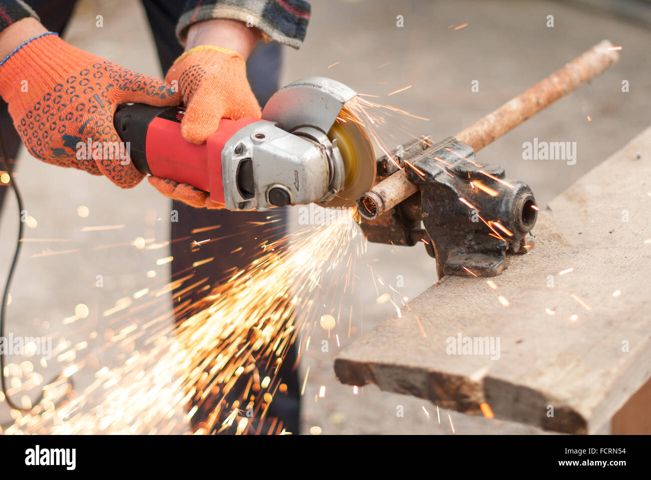Man cuts pipe power saw Stock Photo - Alamy