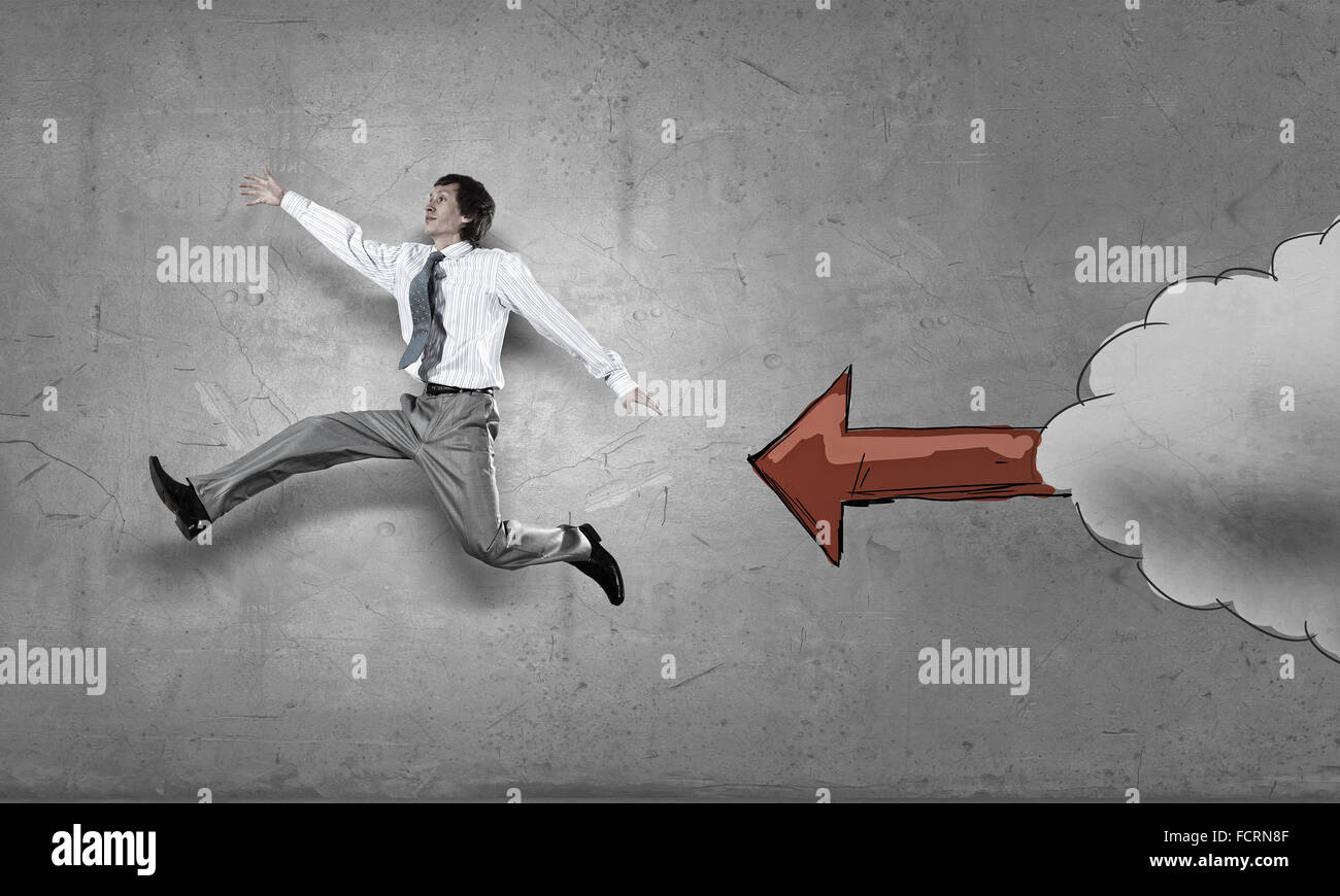 Young speedy businessman running in a hurry Stock Photo - Alamy