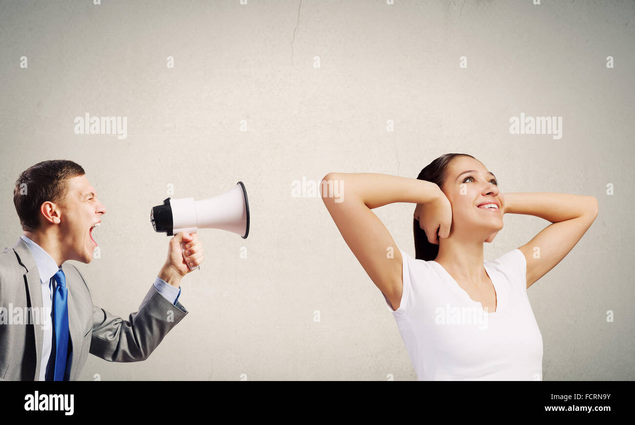 Young furious man screaming agressively in megaphone Stock Photo - Alamy