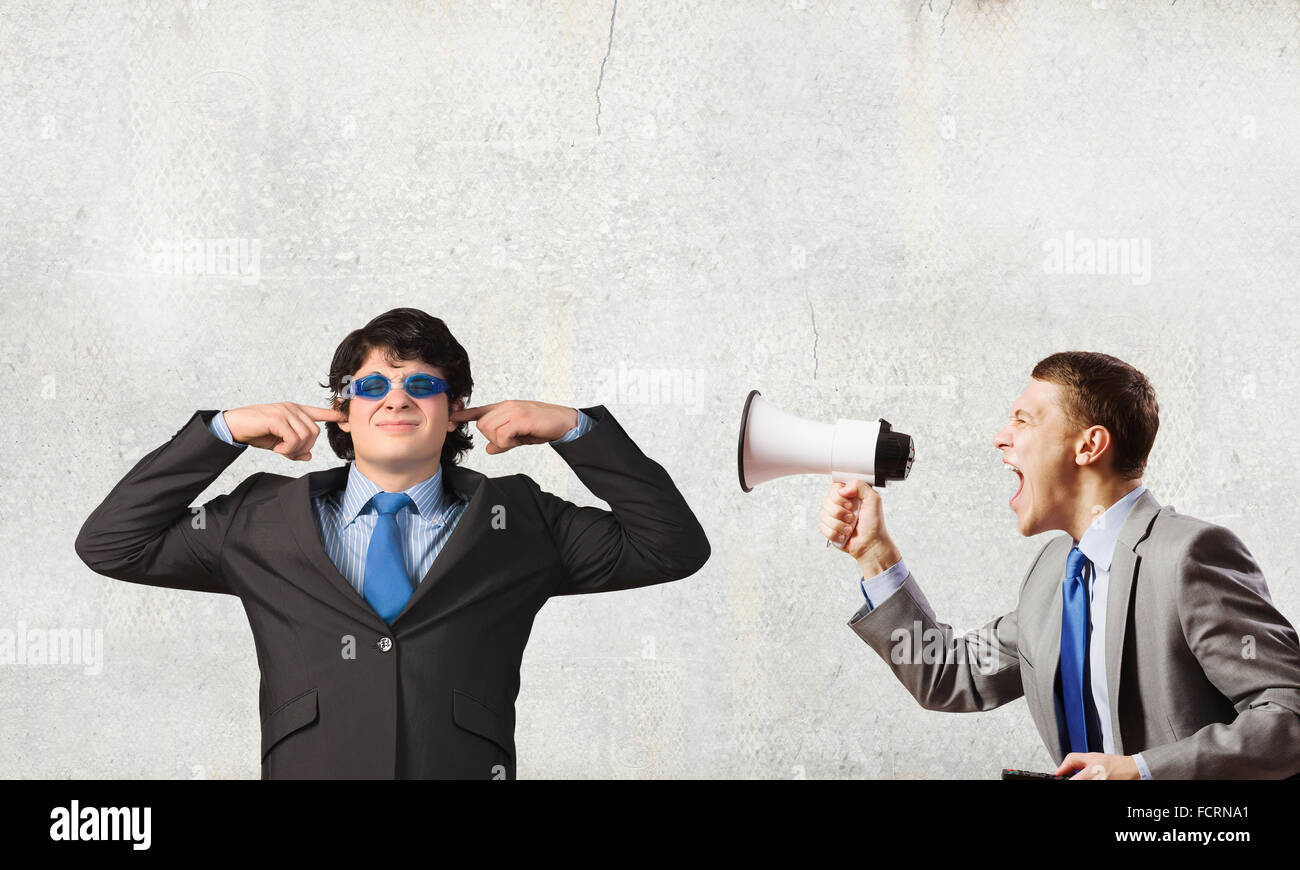 Young furious man screaming agressively in megaphone Stock Photo - Alamy
