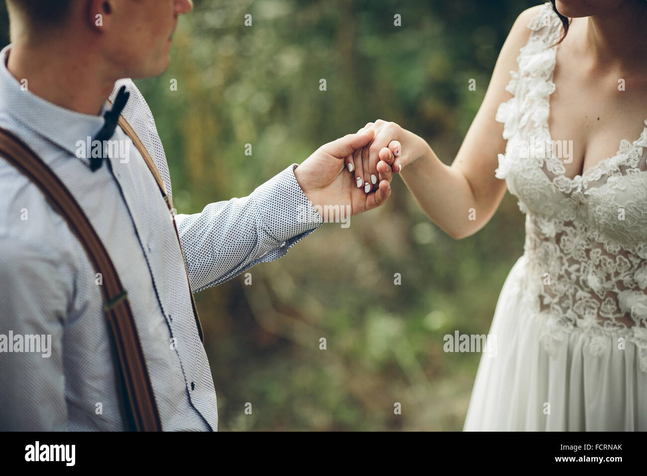bride comes to the groom on the lawn in the forest, close Stock Photo ...