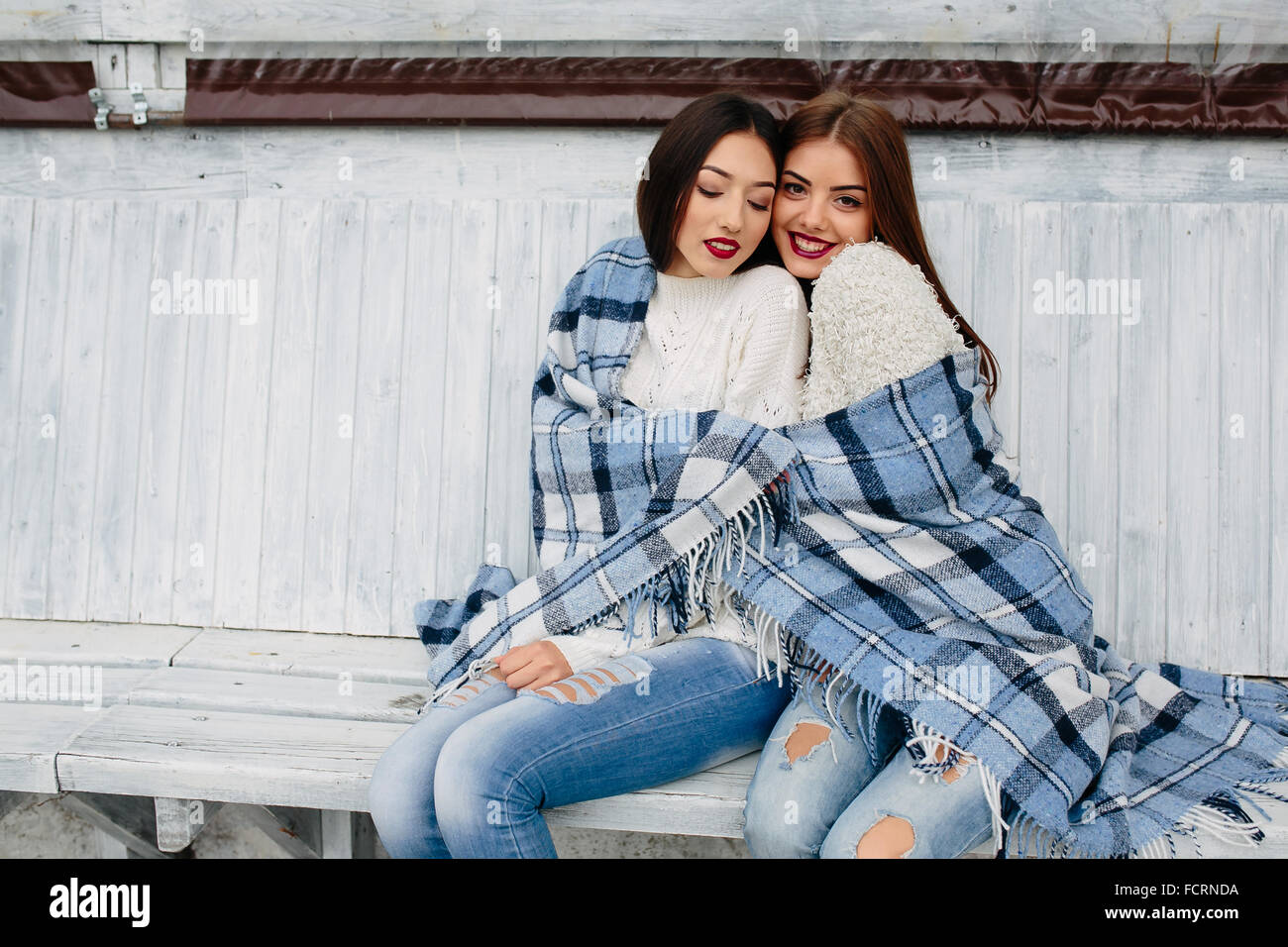 Two girls sit on bench hi-res stock photography and images - Alamy