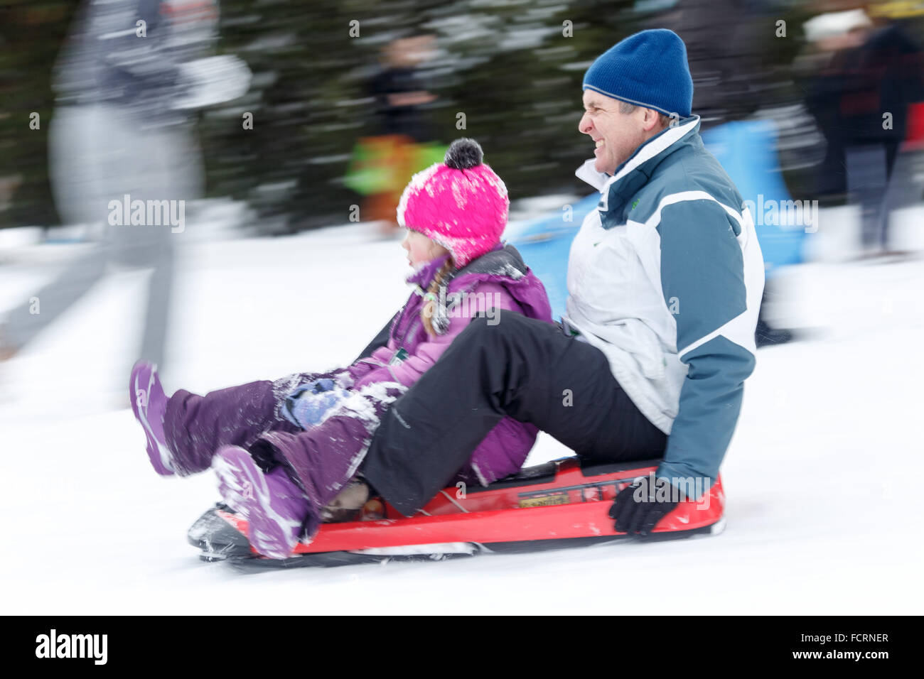 New York, USA. 24th Jan, 2016. People slide down a slope in New York's ...
