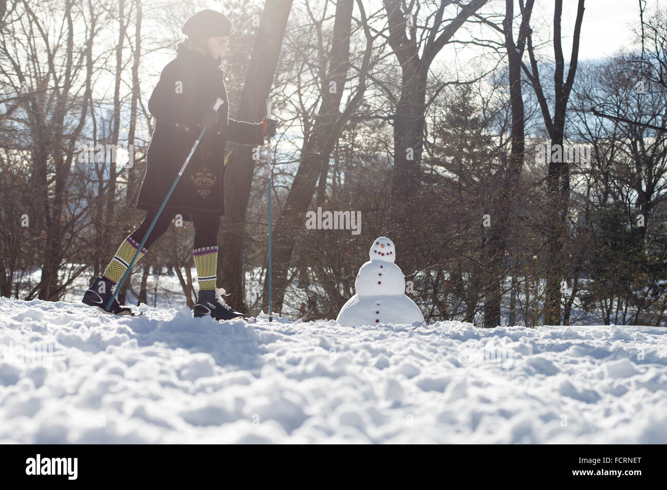 New York, USA. 24th Jan, 2016. A woman skis past a snowman in New York ...