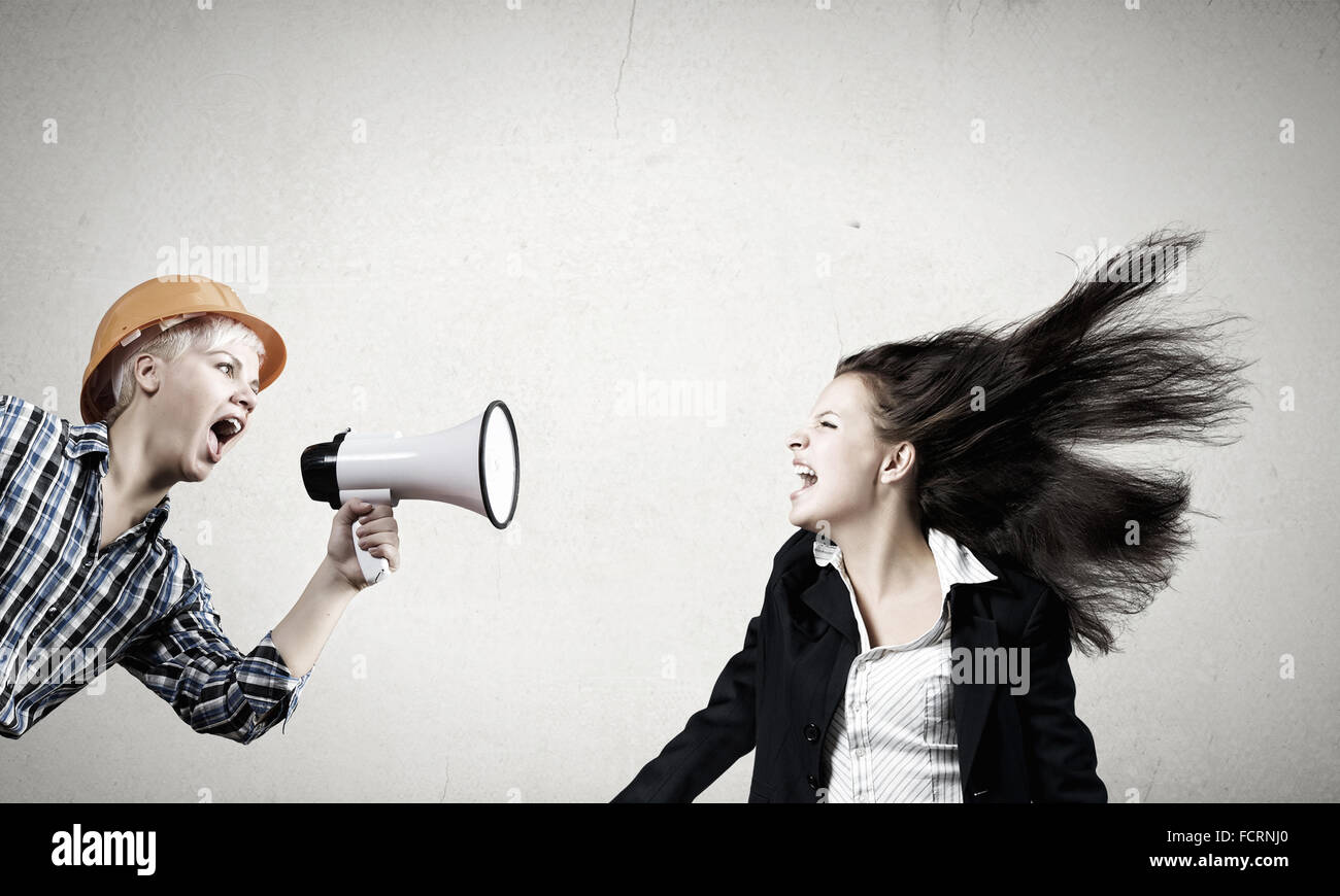 Young furious woman screaming agressively in megaphone Stock Photo - Alamy