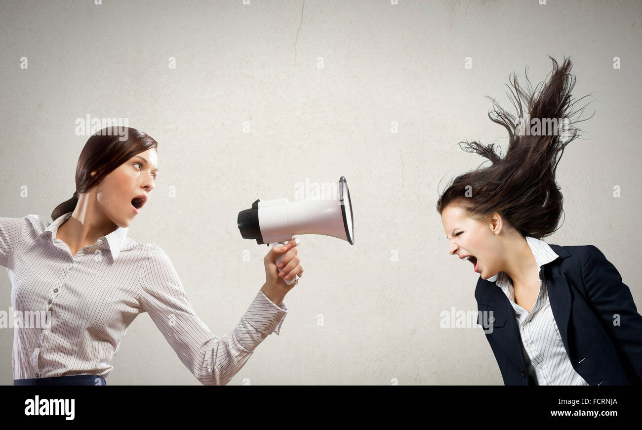 Young furious woman screaming agressively in megaphone Stock Photo - Alamy
