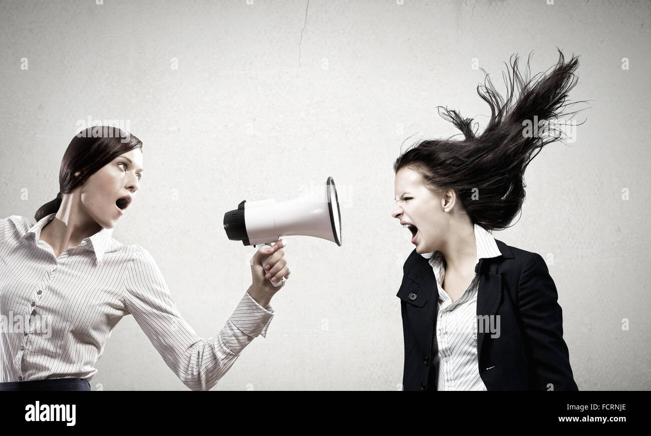 Young furious woman screaming agressively in megaphone Stock Photo - Alamy