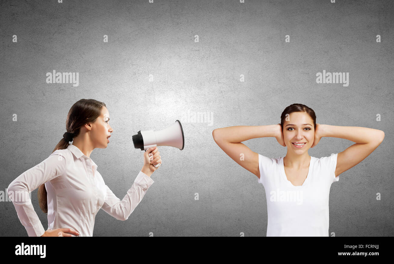 Young furious woman screaming agressively in megaphone Stock Photo - Alamy