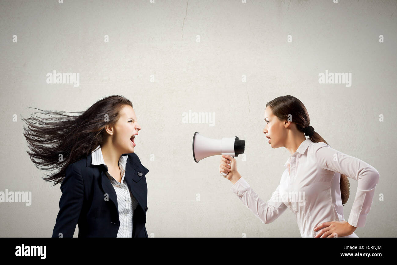 Young furious woman screaming agressively in megaphone Stock Photo - Alamy
